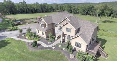 Custom six-bedroom home on equestrian estate with pond
